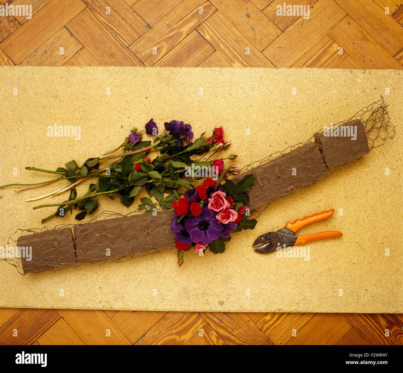 Close-up of materials and tools for making a fresh flower garland Stock ...