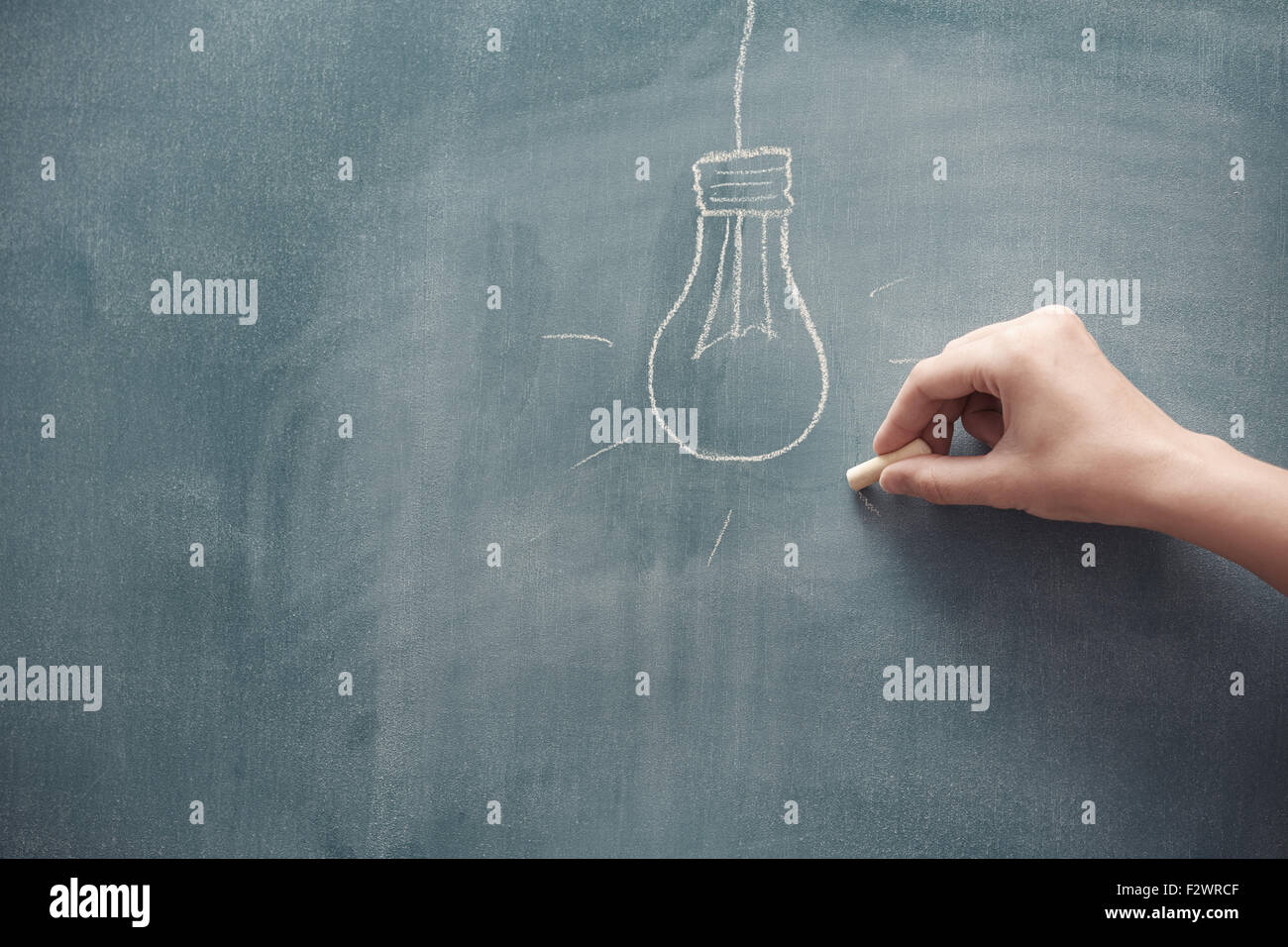 Human hand drawing electric lamp on a blackboard Stock Photo - Alamy