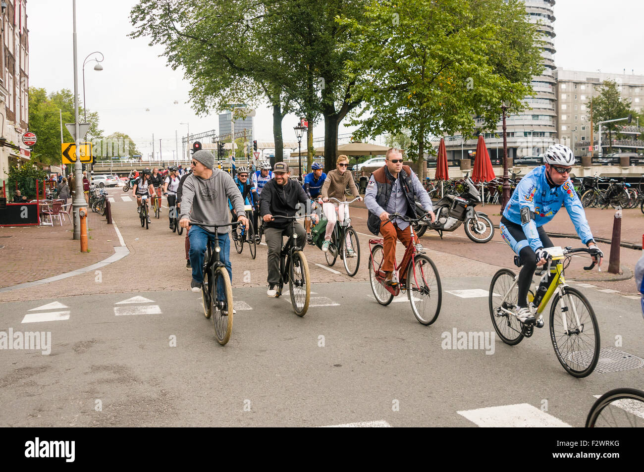 Many cyclists cross the road from Amsterdam Centraal station Stock ... Many cyclists cross the road from Amsterdam Centraal station Stock ...