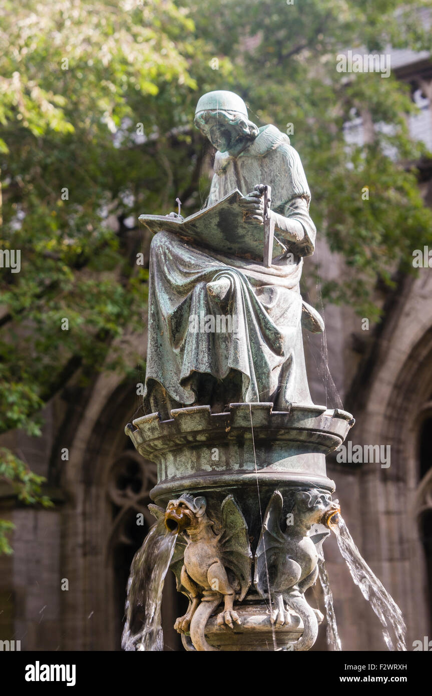 Small bronze statue of a monk, on a fountain inside the courtyard of St ...