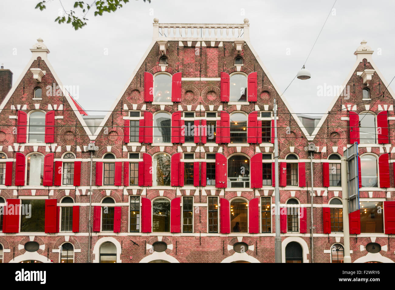 Building in Amsterdam with lots of red window shutters Stock Photo - Alamy