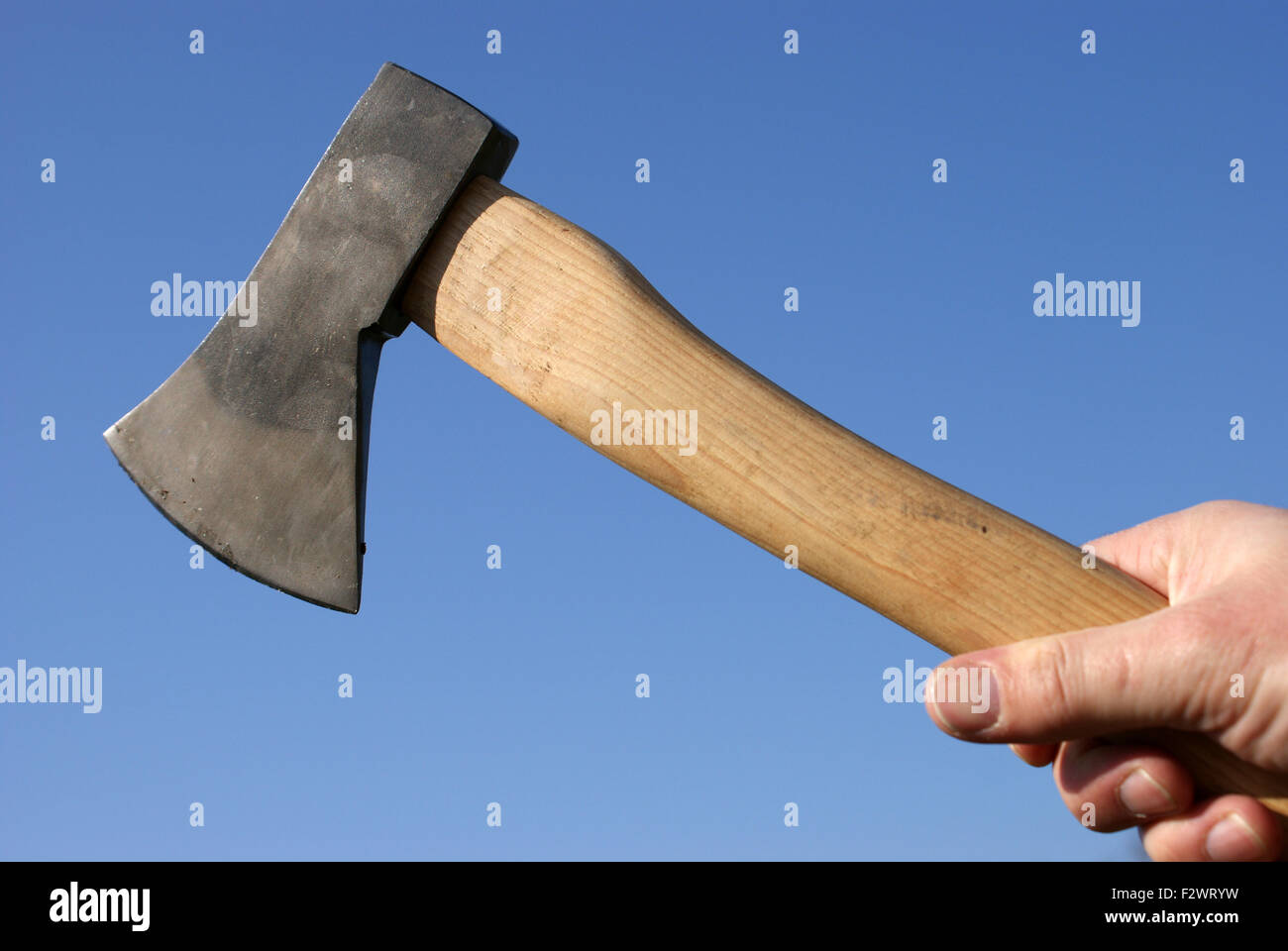 Axe against blue background Stock Photo - Alamy