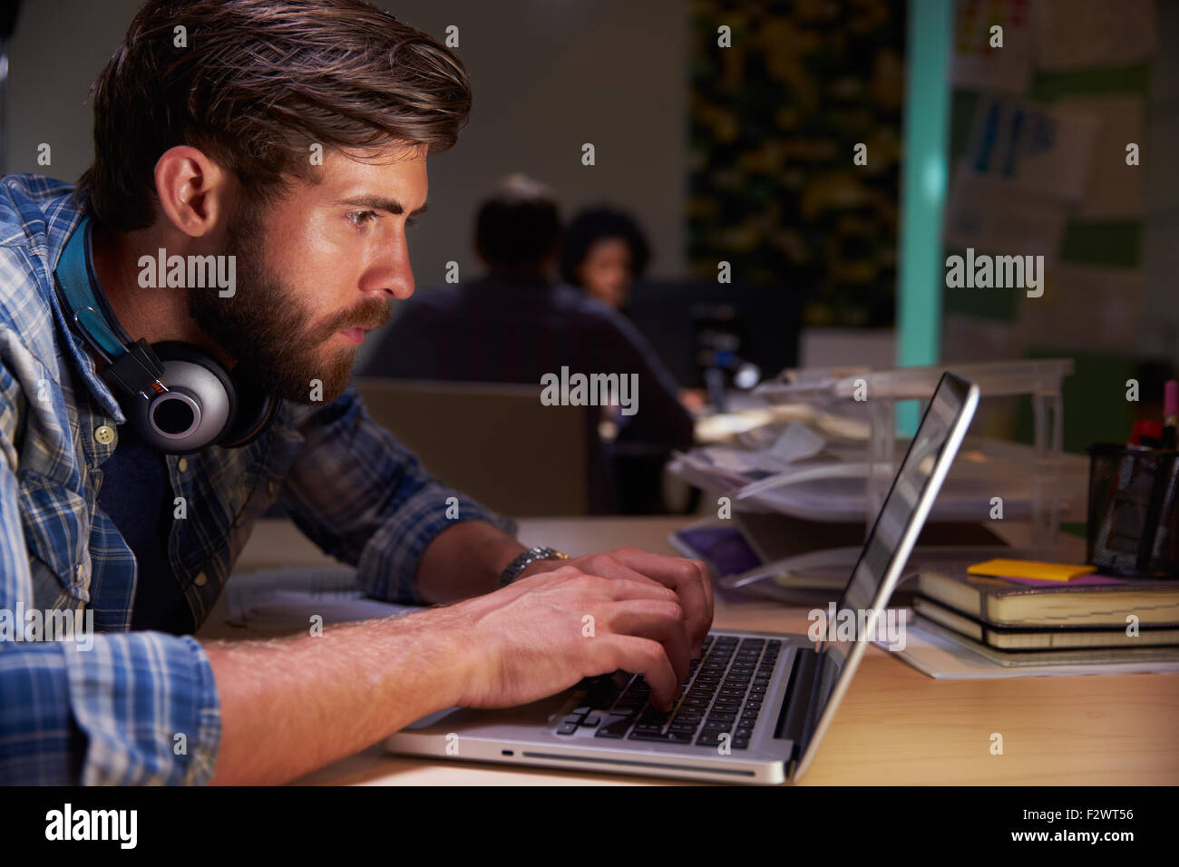 Woman listening music working late hi-res stock photography and images ...