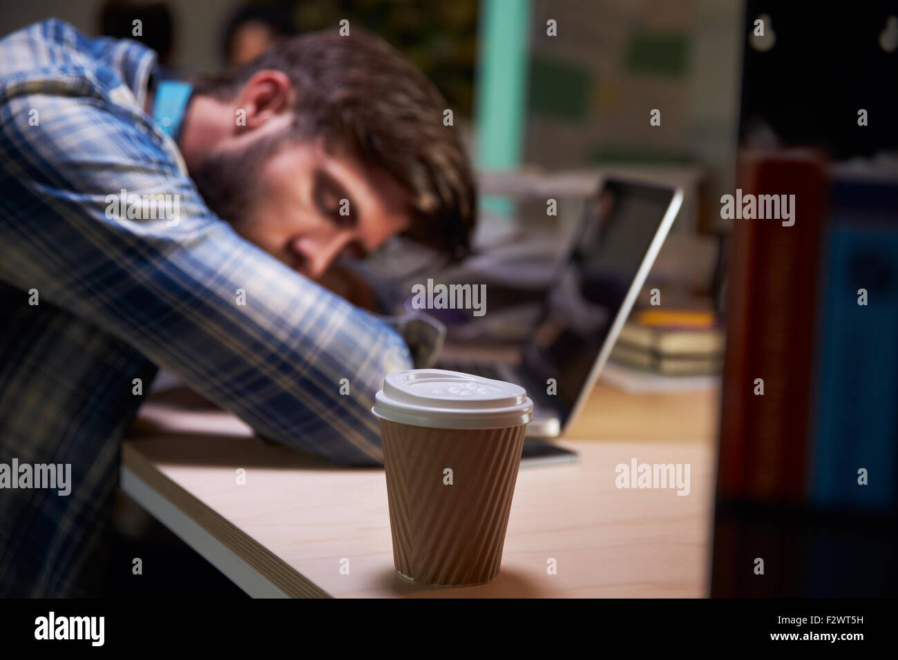 Male Office Worker Asleep At Desk Working Late On Laptop Stock Photo ...