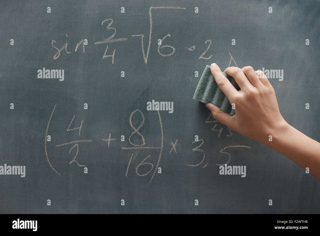 Hand of student studying mathematics and writing on a blackboard Stock ...