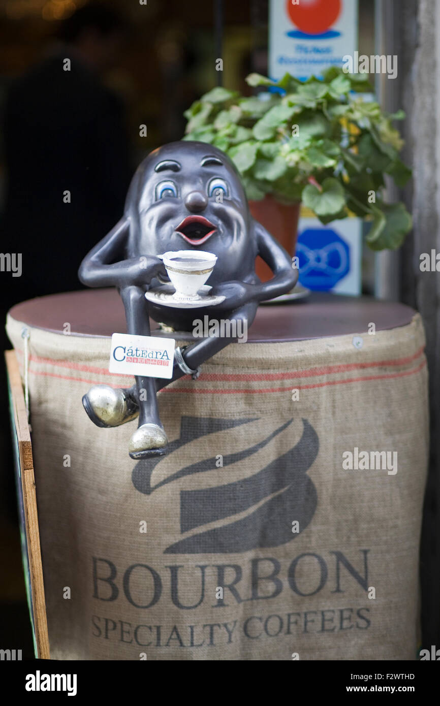 Coffee bean statue drinking a cup of coffee Stock Photo - Alamy