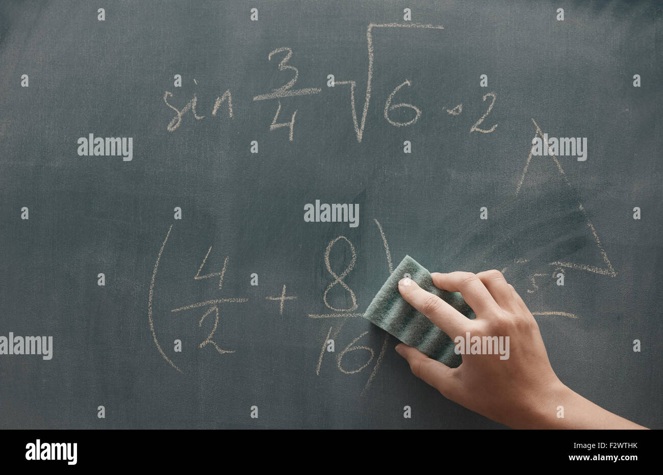 Hand of student studying mathematics and writing on a blackboard Stock ...