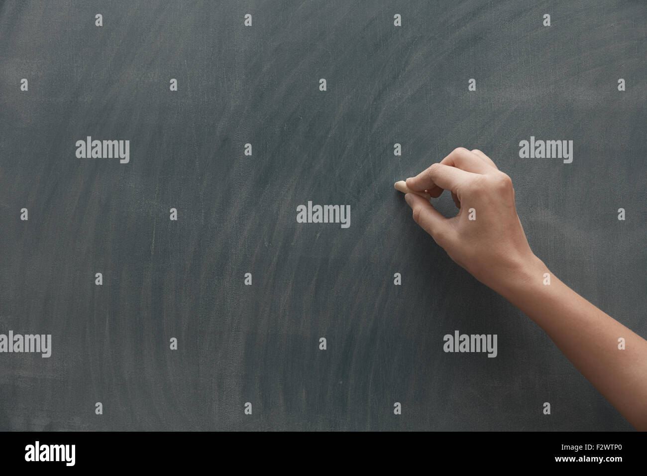 Human hand with chalk at the blackboard Stock Photo - Alamy