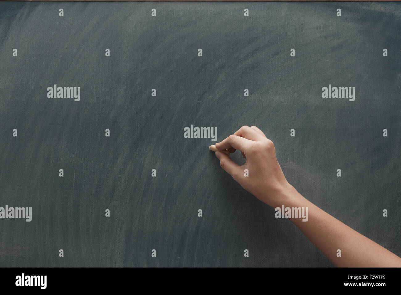 Human hand with chalk at the blackboard Stock Photo - Alamy
