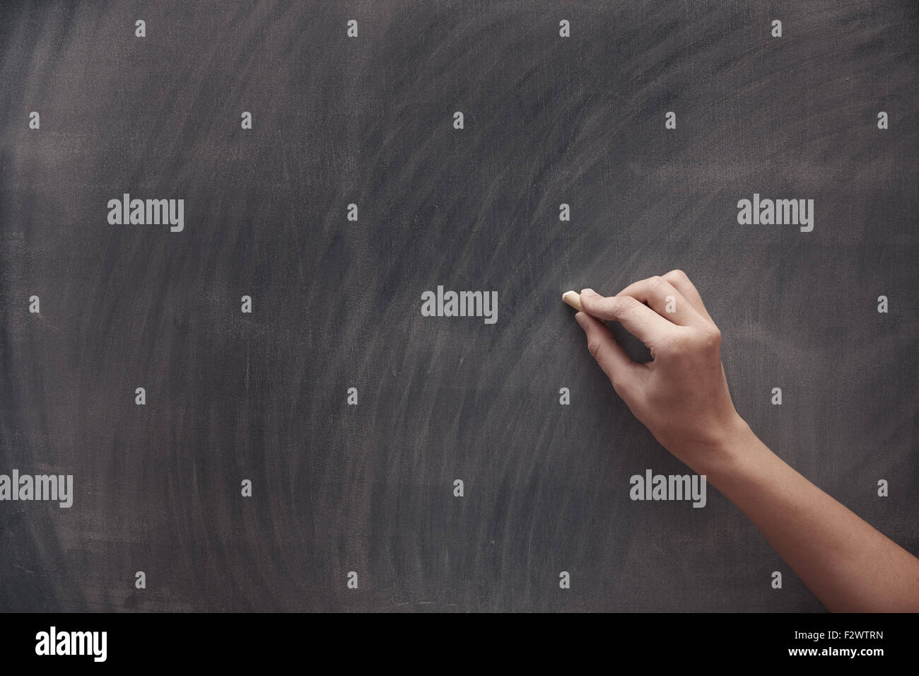Human hand with chalk at the blackboard Stock Photo - Alamy