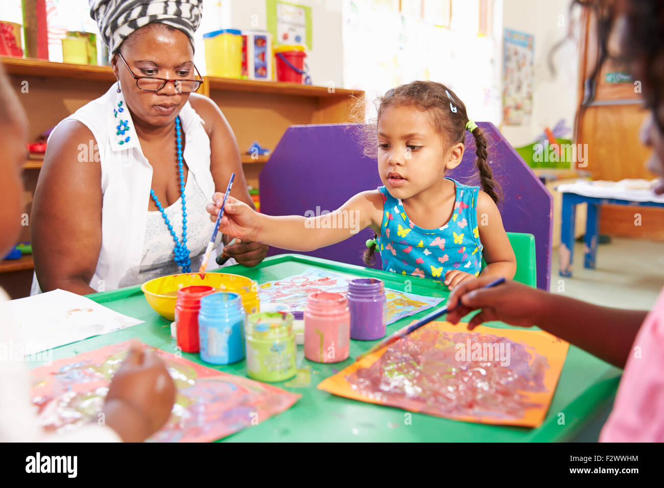Teacher sitting with kids in a preschool class, close up Stock Photo ...