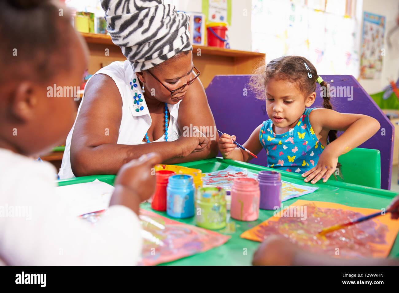 Teacher sitting with kids in a preschool class, close up Stock Photo ...