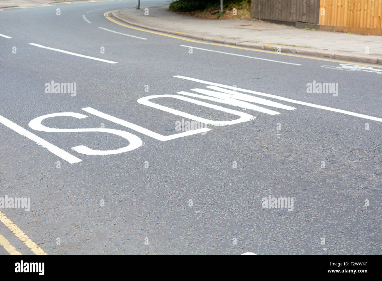 Slow down sign painted on road in Bedford, Bedfordshire, England Stock ...