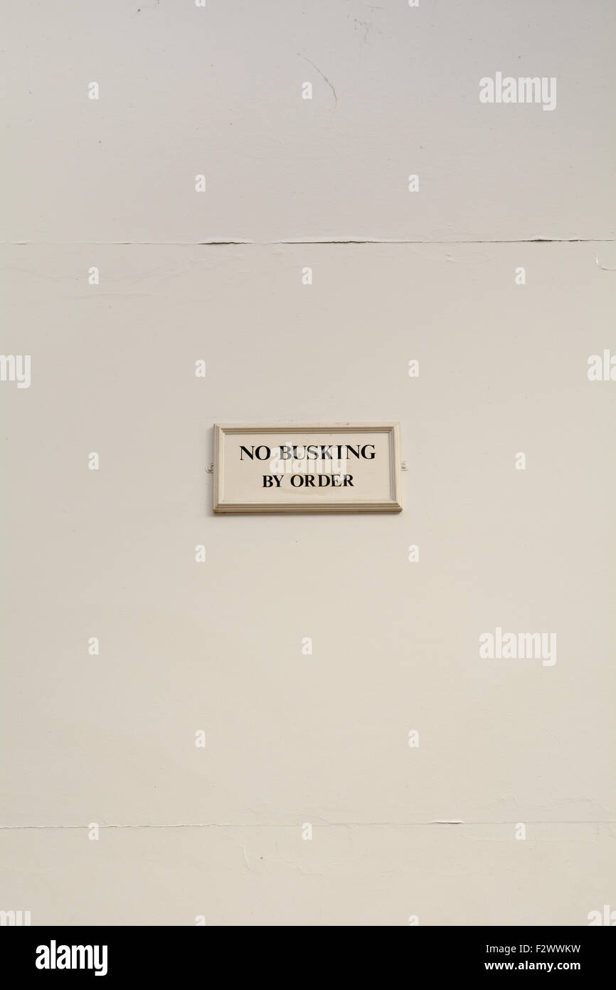 'No Busking by Order' sign on wall in Arcade Walk in Bedford ...