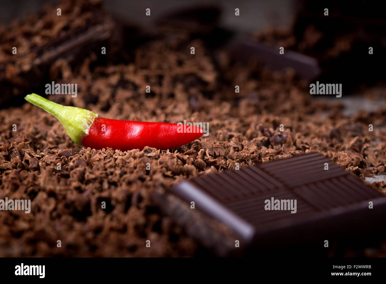 Grated Chocolate with Red Chilli Pepper on wooden background closeup ...