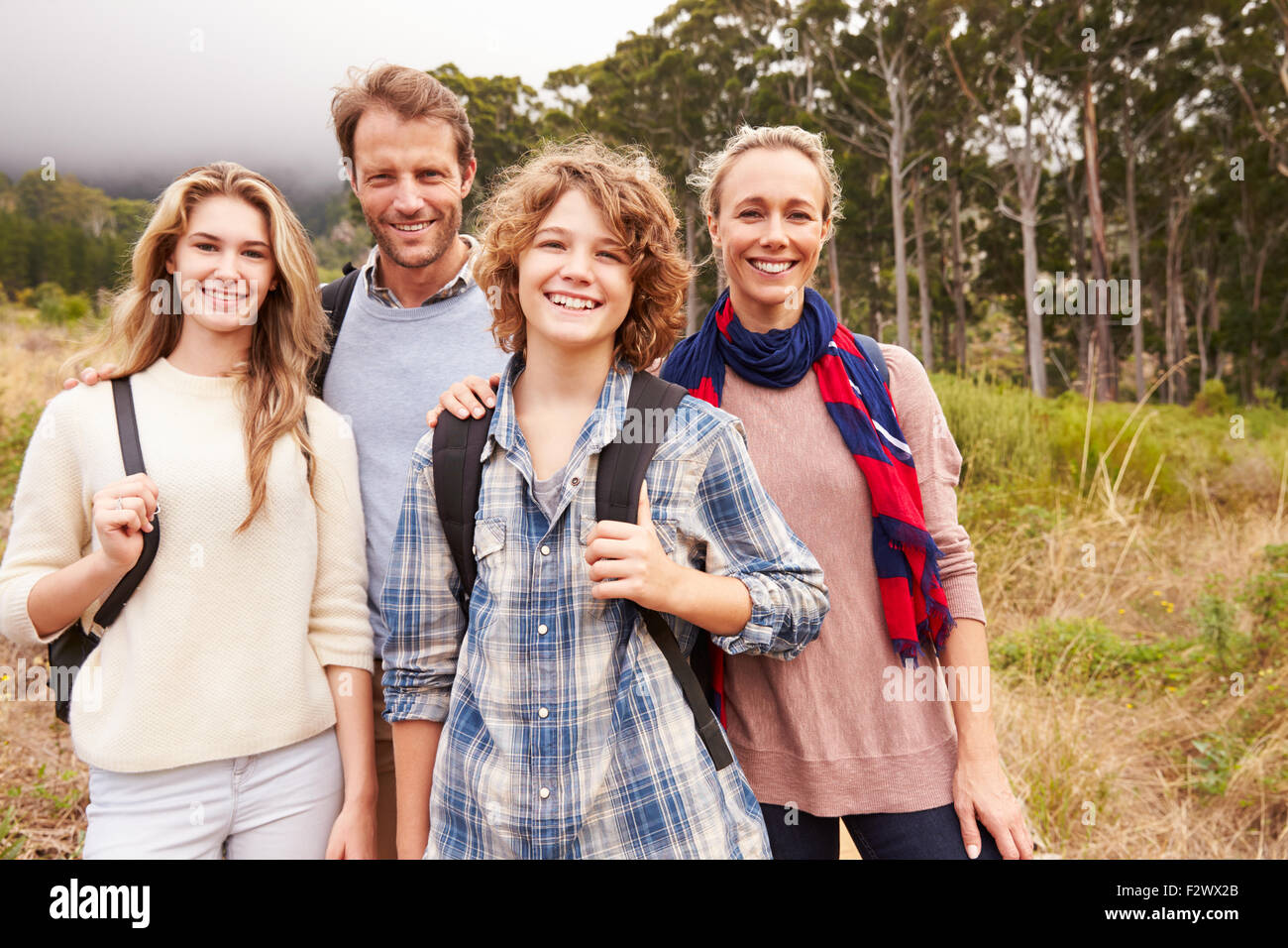 Happy family outdoor portrait in a forest Stock Photo - Alamy
