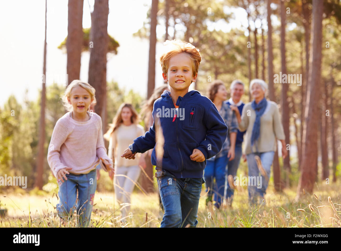 Multi-generation family walking in countryside, kids running Stock ...