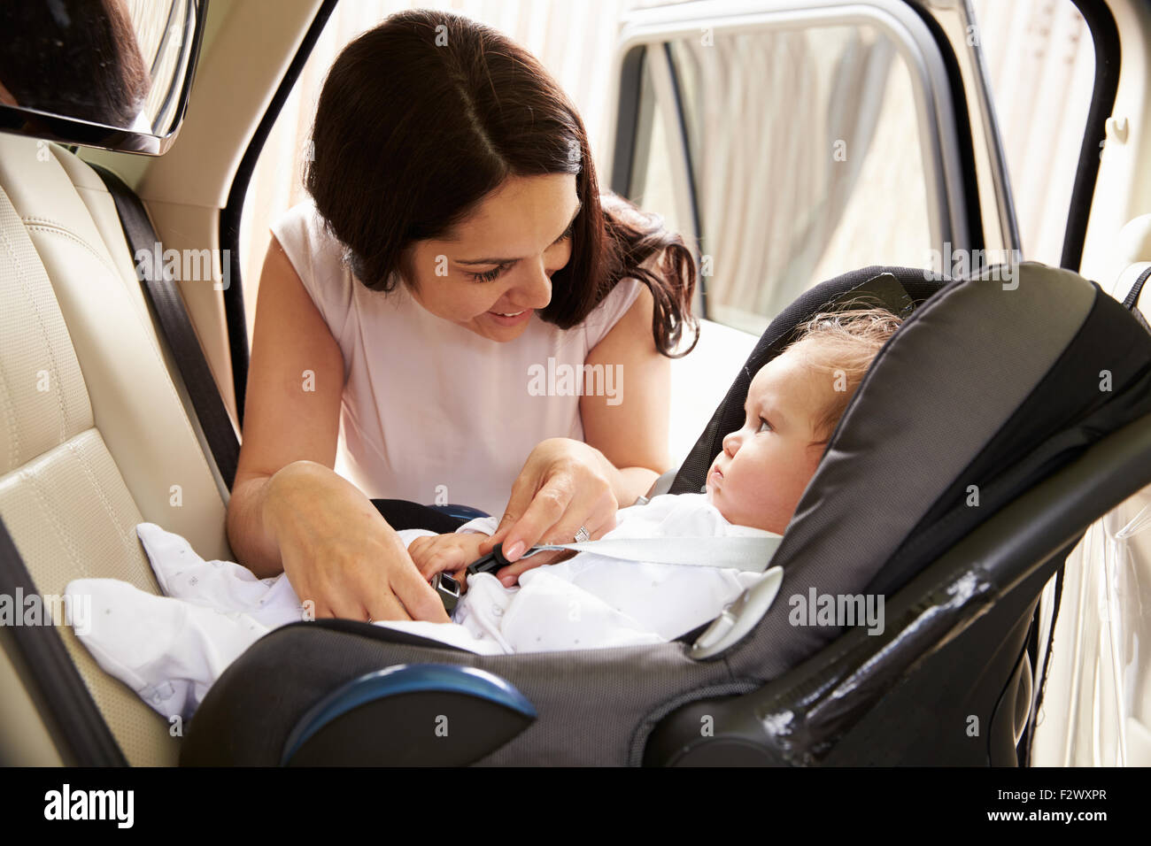 Fastening child into car seat hi-res stock photography and images - Alamy