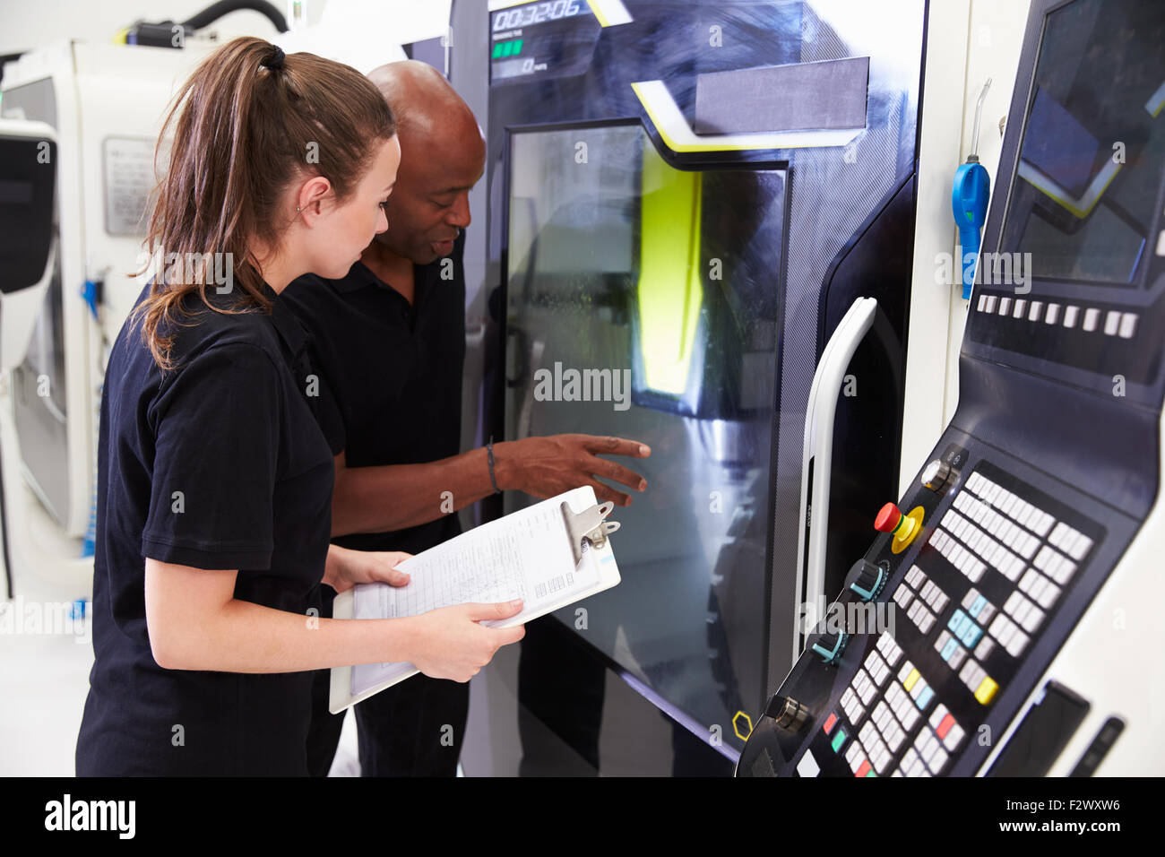 Black female factory engineer teaching hi-res stock photography and ...