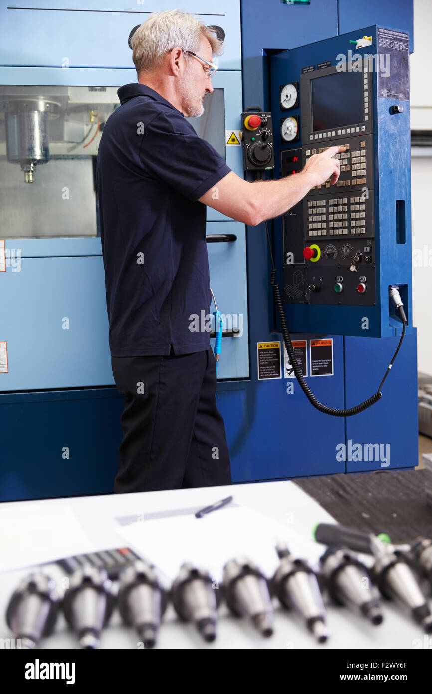 Male Engineer Operating CNC Machinery On Factory Floor Stock Photo - Alamy