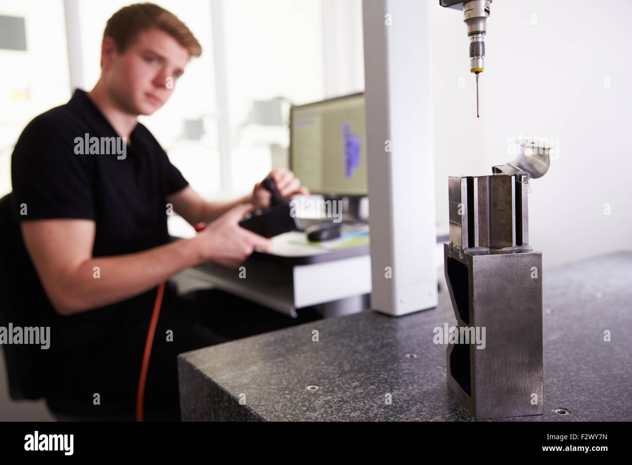 Male Engineer Using CAD System To Work On Component Stock Photo - Alamy