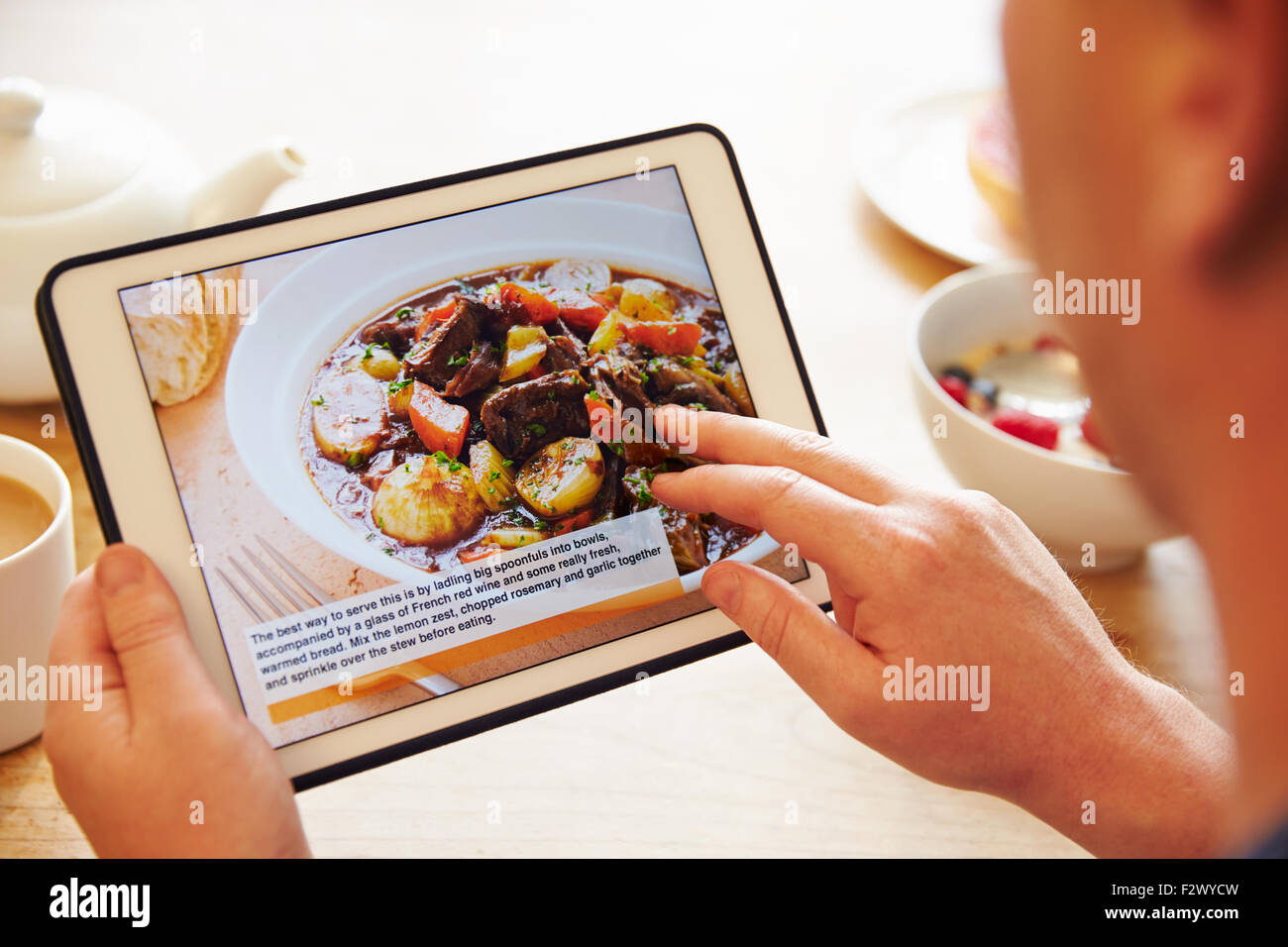 Person At Breakfast Looking At Recipe App On Digital Tablet Stock Photo ...