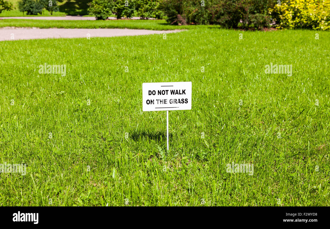 Notice board on the lawn with text "Do not walk on the grass Stock ...