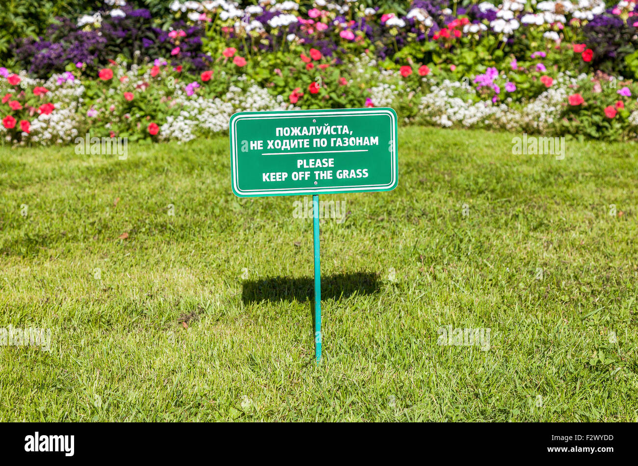 Notice board on the lawn with text "Please keep of the grass Stock ...