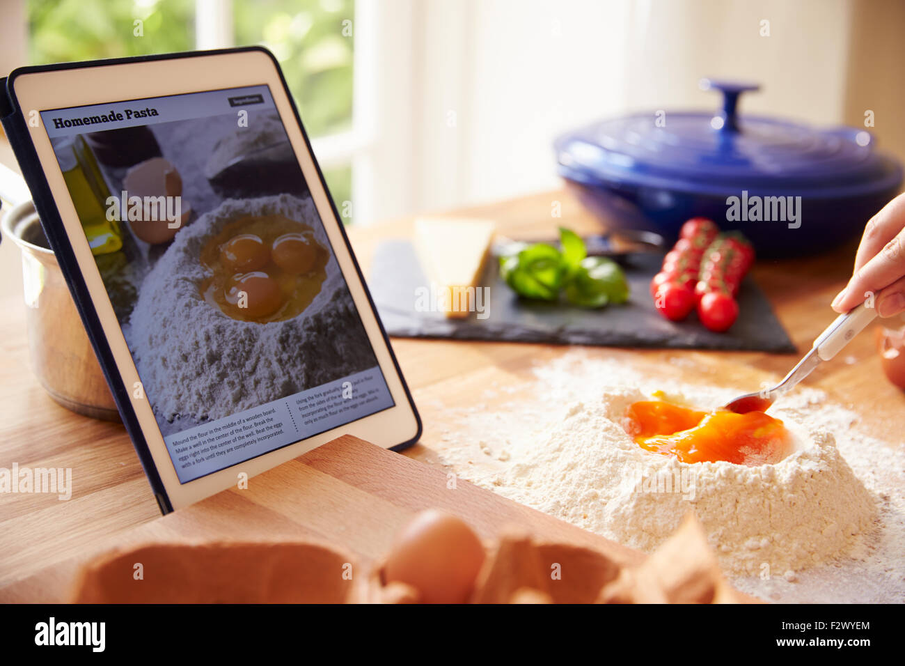 Person Following Pasta Recipe Using App On Digital Tablet Stock Photo ...