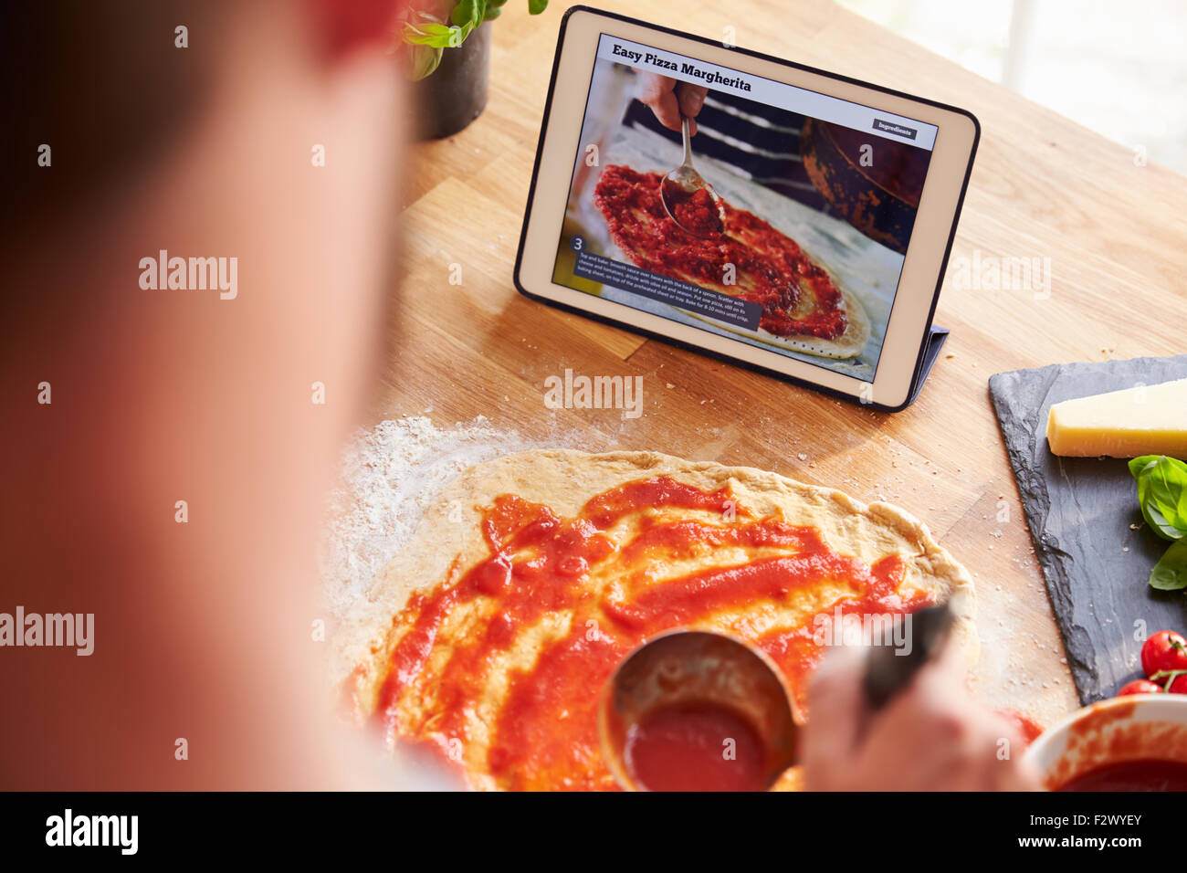 Person Following Pizza Recipe Using App On Digital Tablet Stock Photo ...