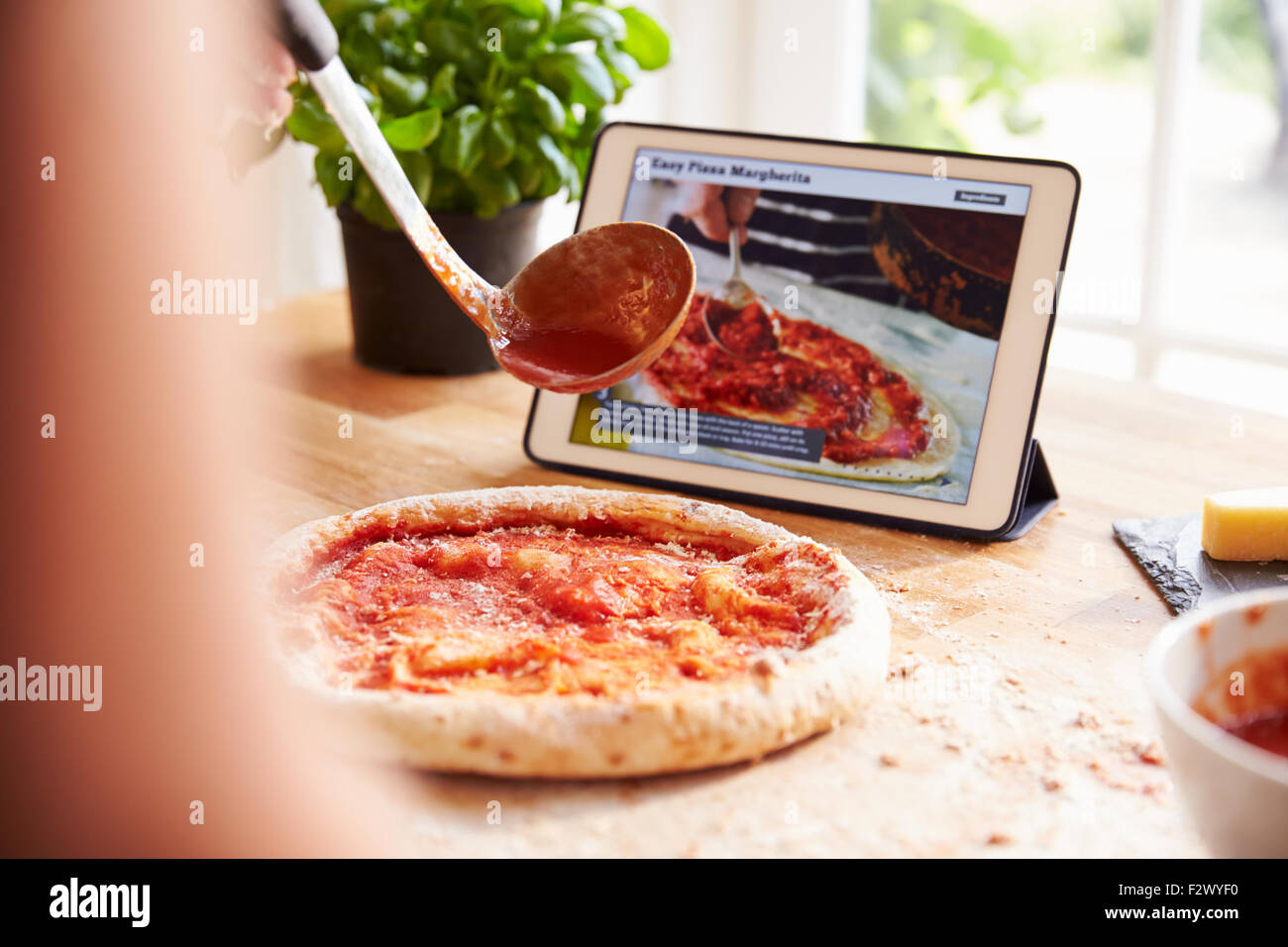 Person Following Pizza Recipe Using App On Digital Tablet Stock Photo ...