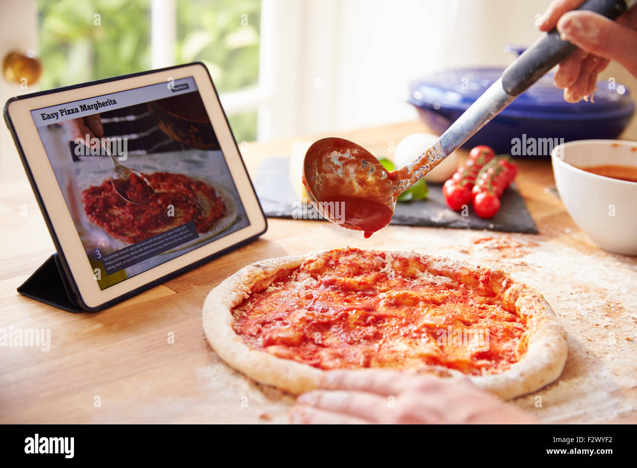 Person Following Pizza Recipe Using App On Digital Tablet Stock Photo ...