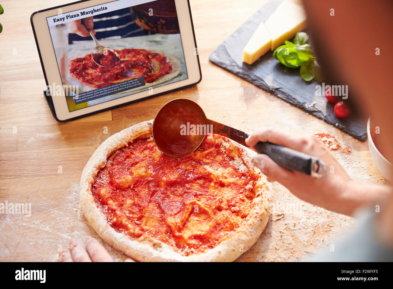 Person Following Pizza Recipe Using App On Digital Tablet Stock Photo ...