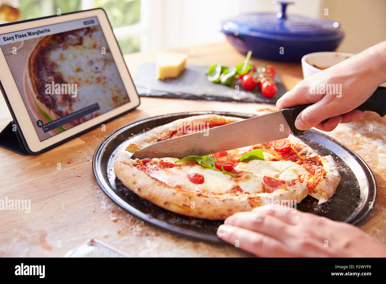 Person Following Pizza Recipe Using App On Digital Tablet Stock Photo ...