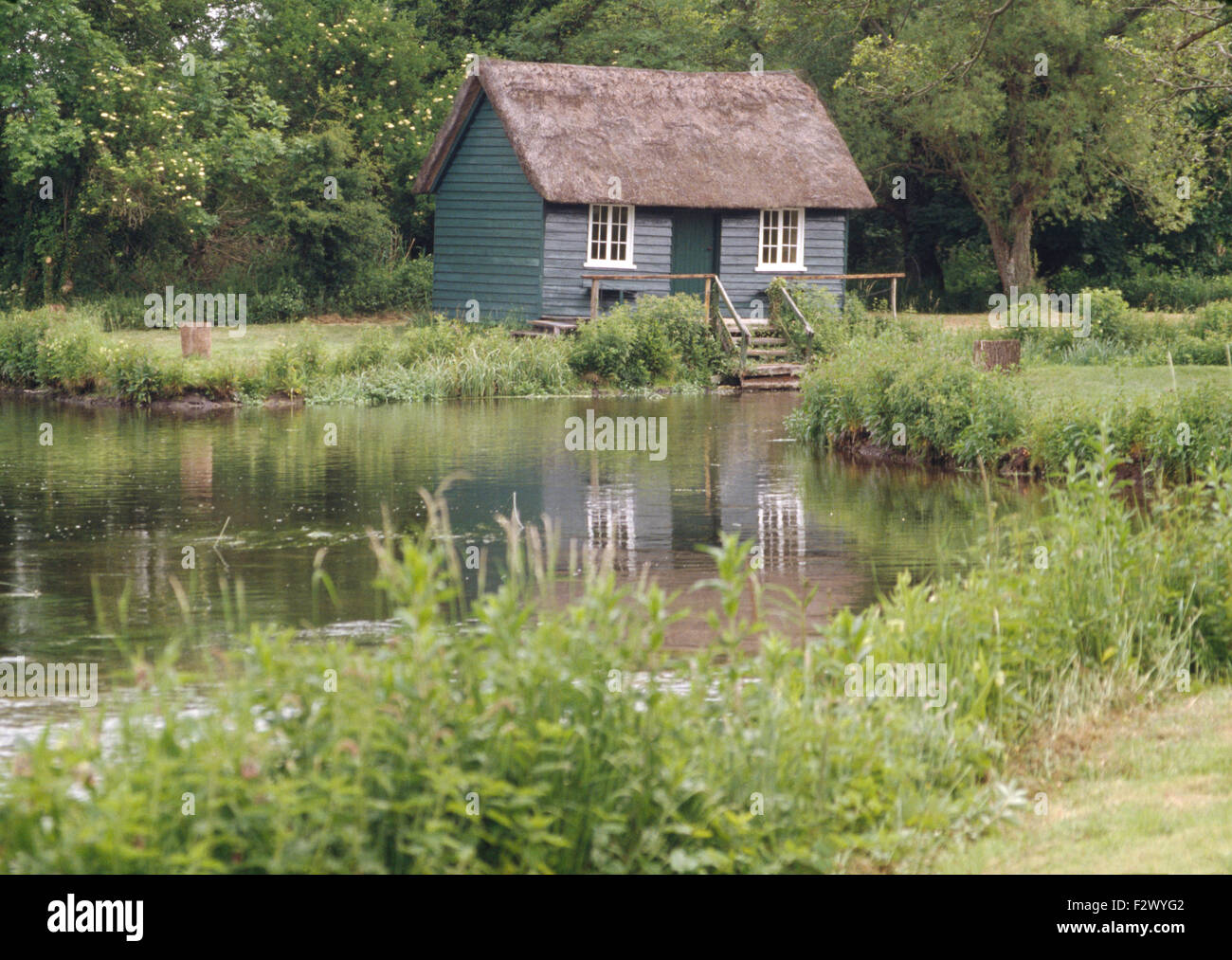 Exterior of wooden hut beside lake Stock Photo - Alamy