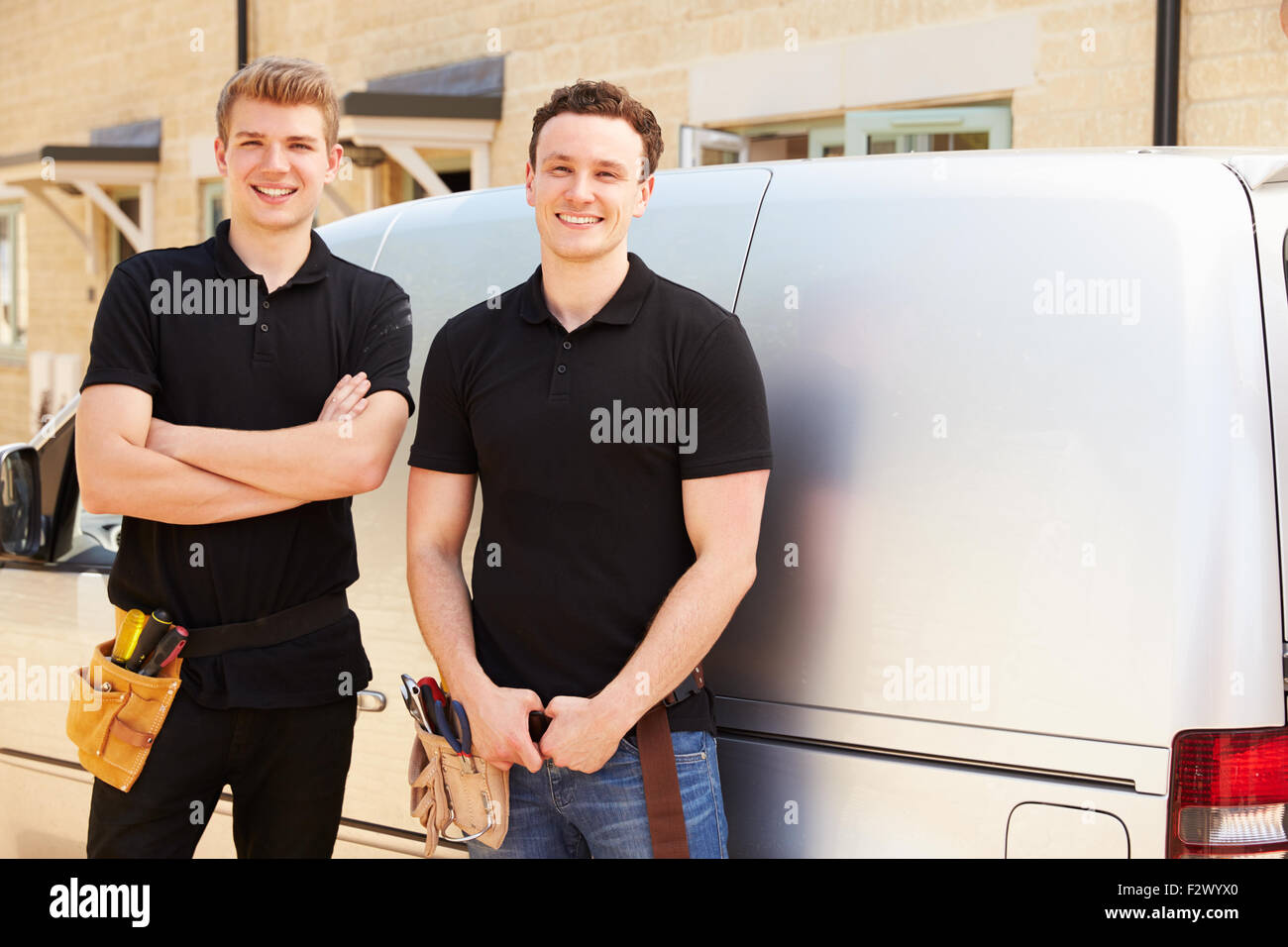 Portrait of two young tradesmen by their van Stock Photo - Alamy