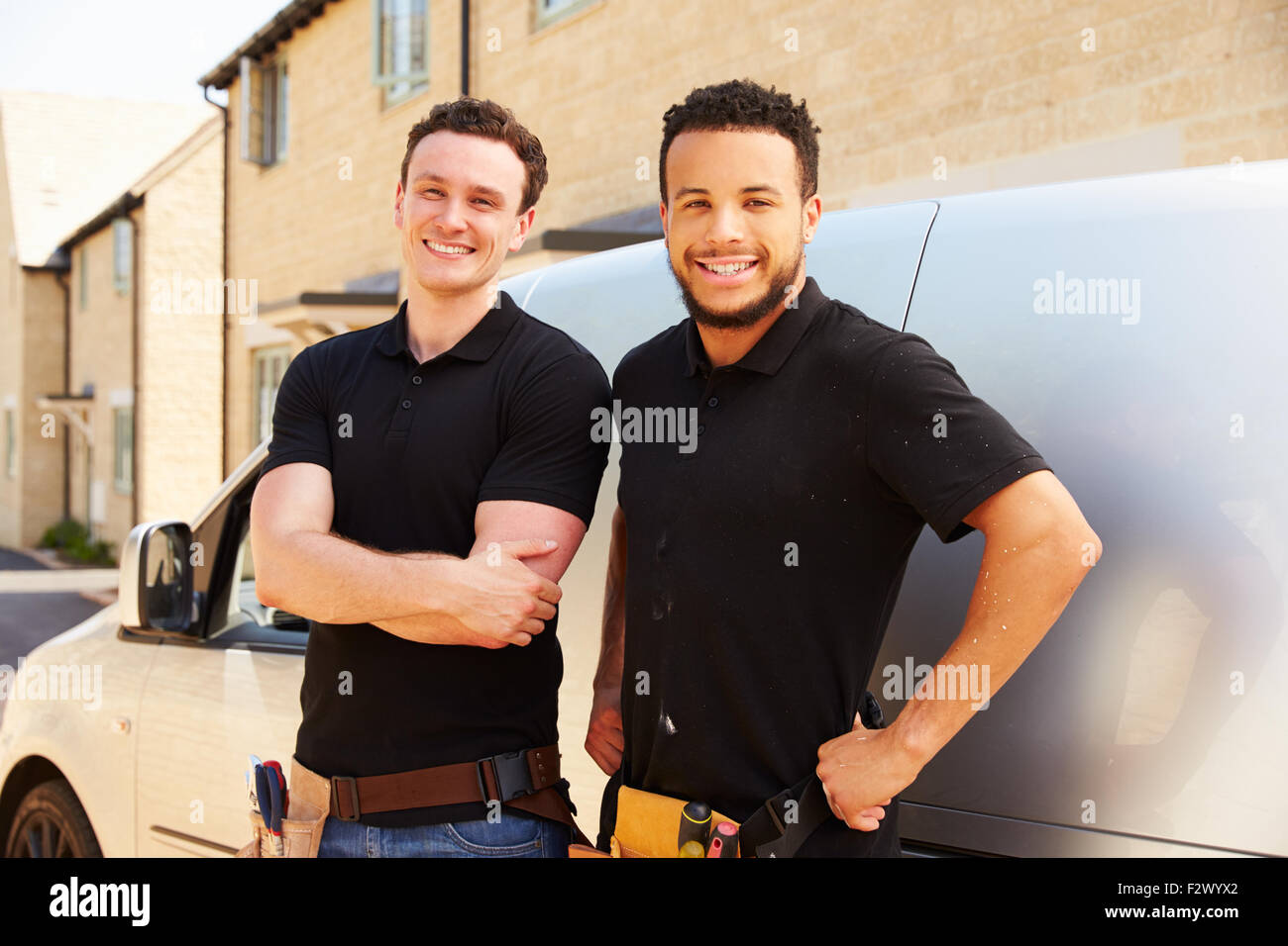 Portrait of two young tradesmen by their van Stock Photo - Alamy
