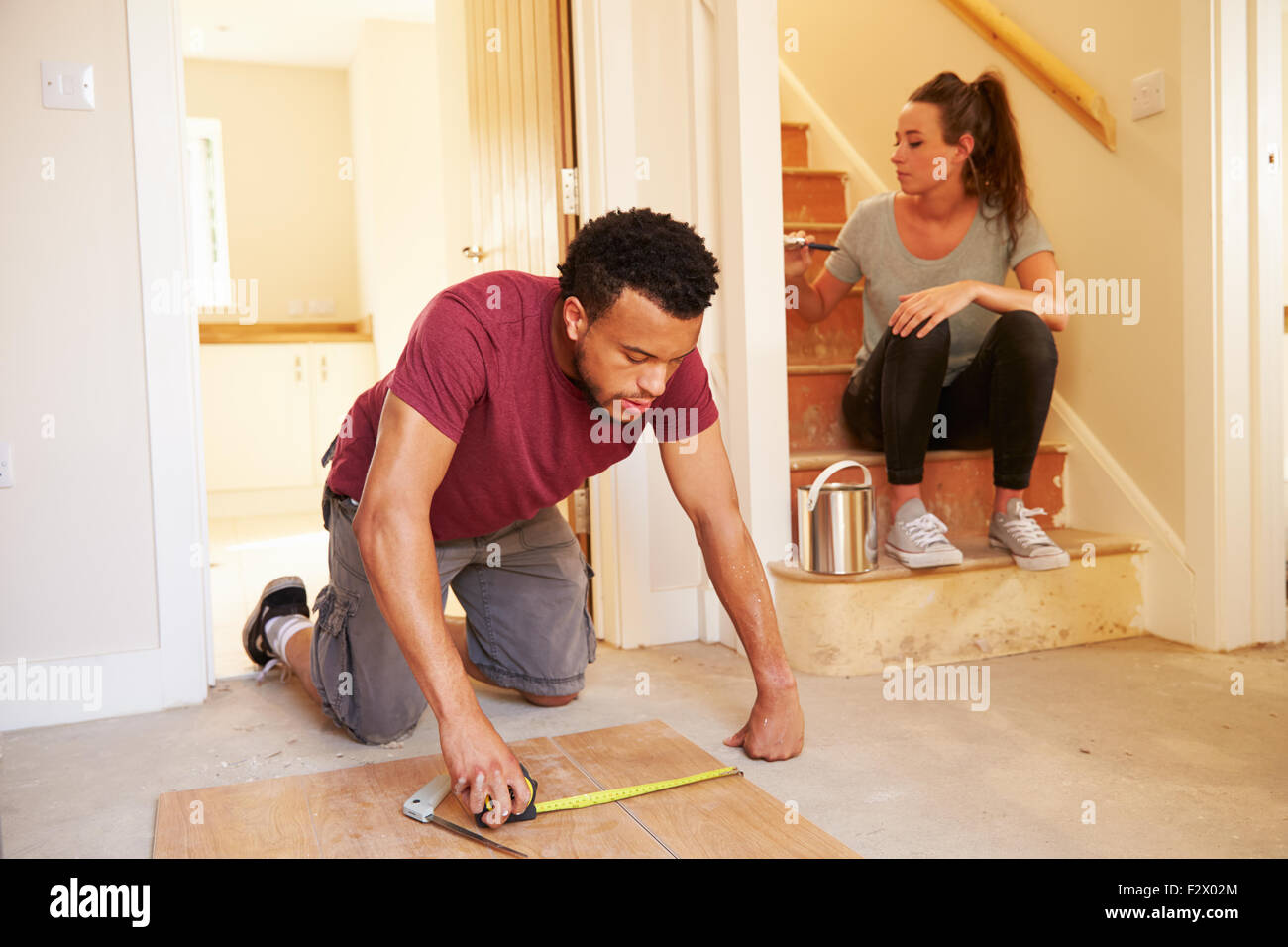 Young homeowners decorating their house Stock Photo - Alamy