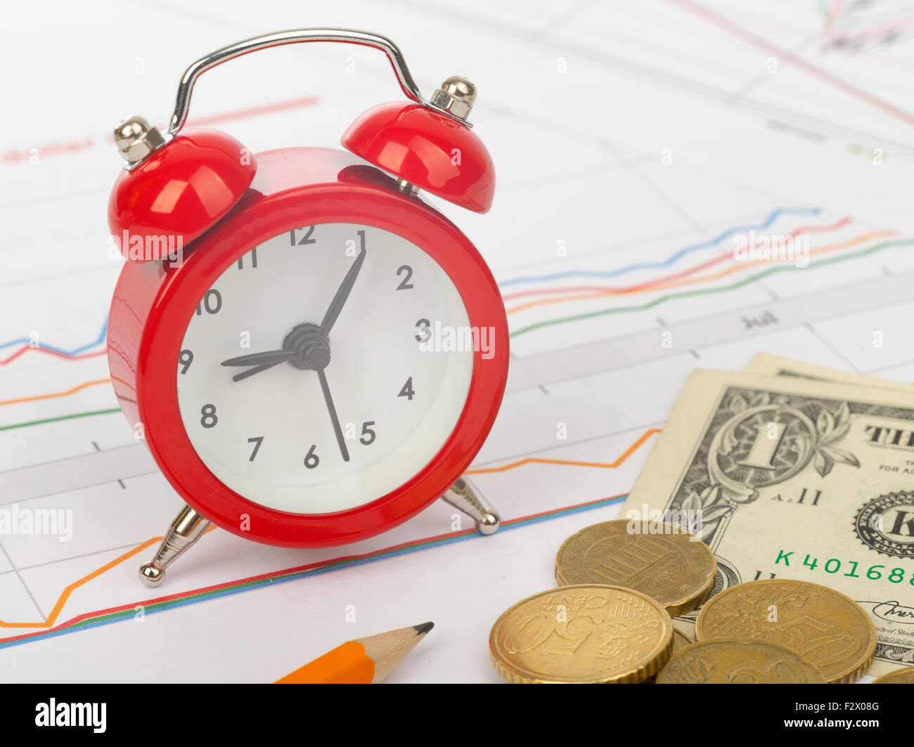 Alarm clock with business documents Stock Photo - Alamy