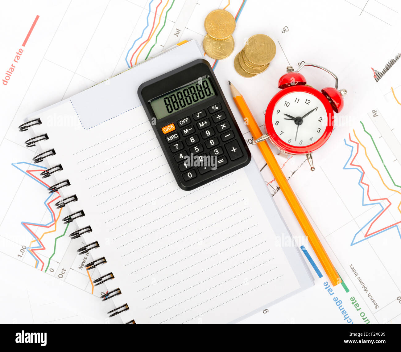 Alarm clock with notebook and calculator Stock Photo - Alamy