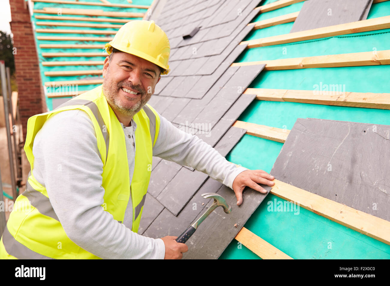 Slate tile fixing hammer roof hi-res stock photography and images - Alamy