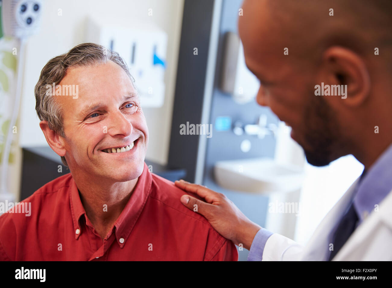 Male Patient Being Reassured By Doctor In Hospital Room Stock Photo - Alamy