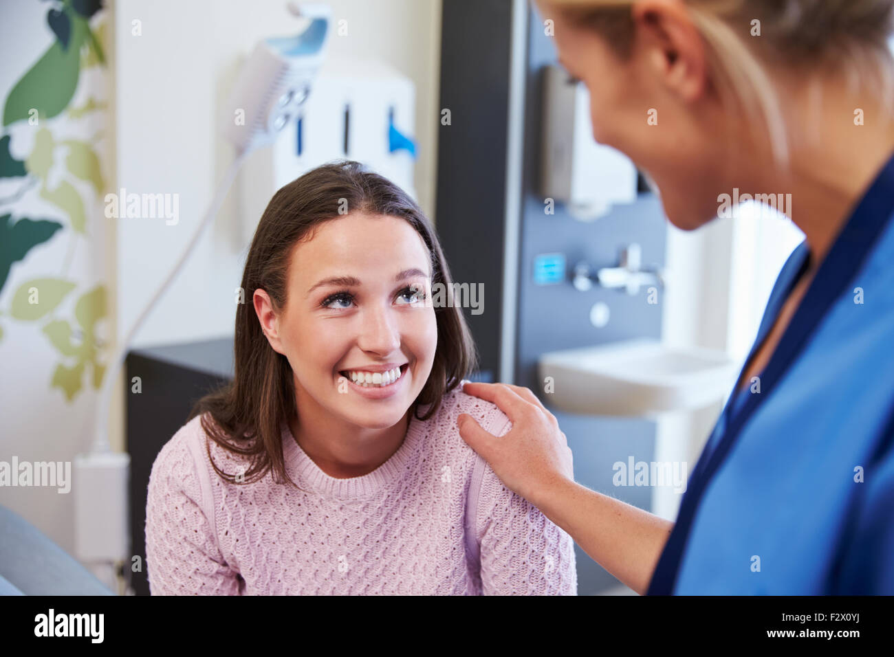 Female Patient Being Reassured By Doctor In Hospital Room Stock Photo ...