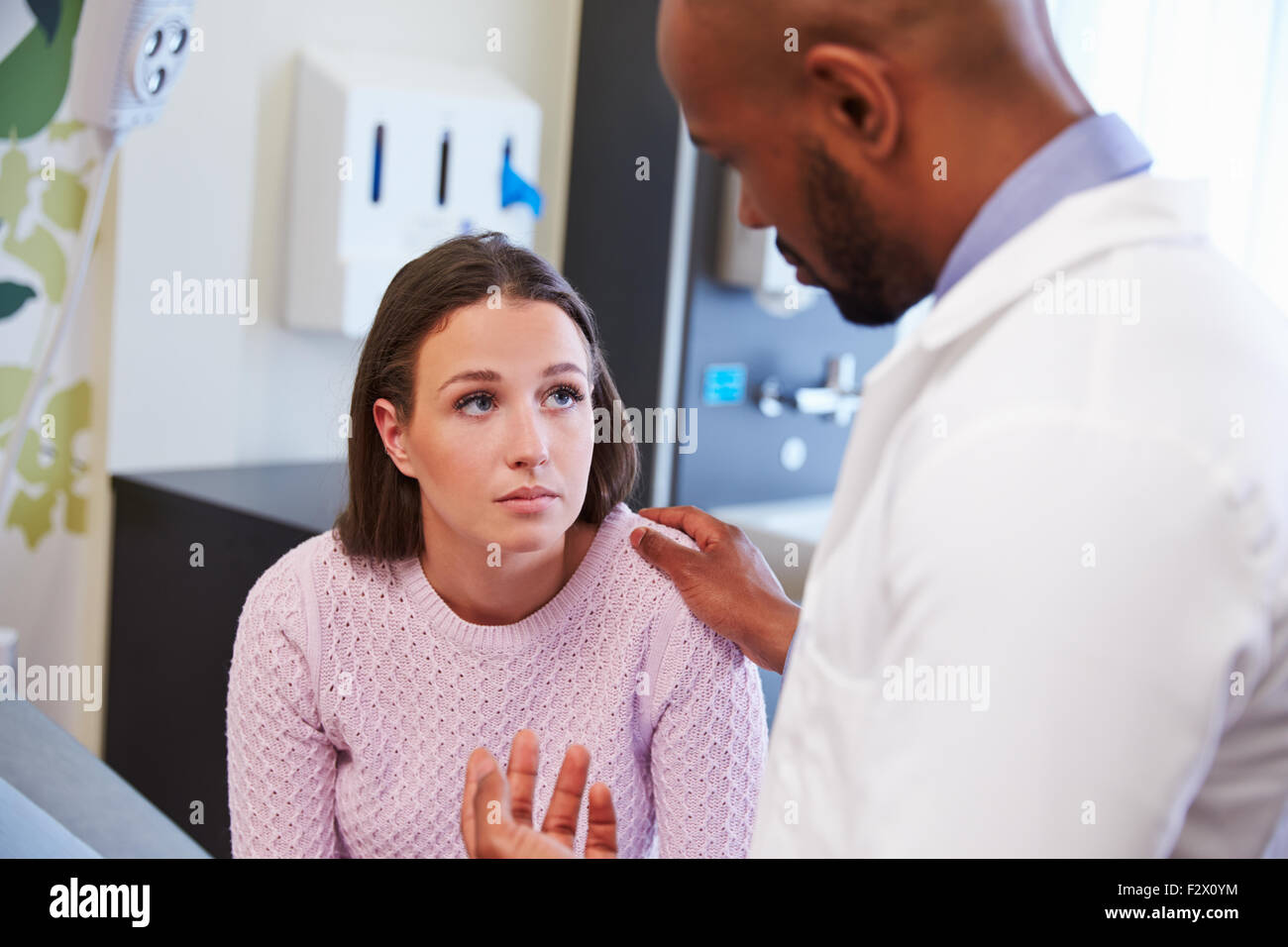 Female Patient Being Reassured By Doctor In Hospital Room Stock Photo ...