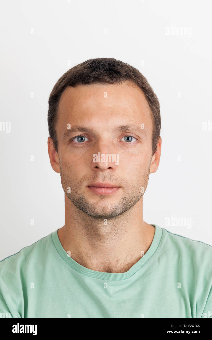 Young serious Caucasian man in casual clothing, studio portrait over ... Young serious Caucasian man in casual clothing, studio portrait over ...