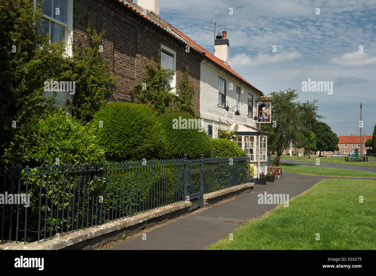 Sunny summer view of attractive, traditional, old, English rural pub ...