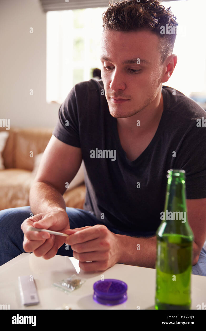 Young Man Smoking Marijuana At Home Stock Photo - Alamy