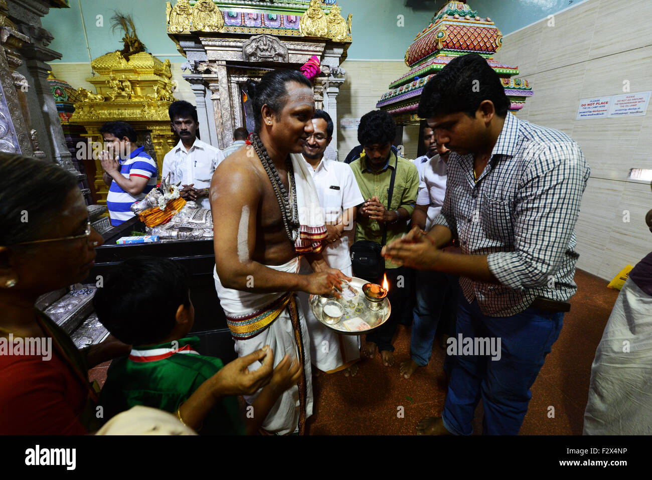 A Hindu priest performing a puja ceremony inside the Sri ...