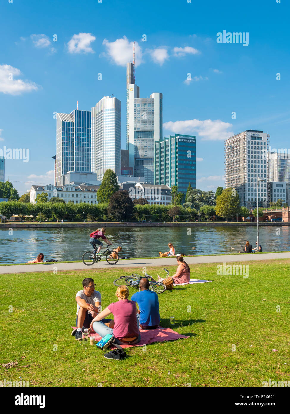 Germany, Hesse, Frankfurt, People at River Main with skyline in ...
