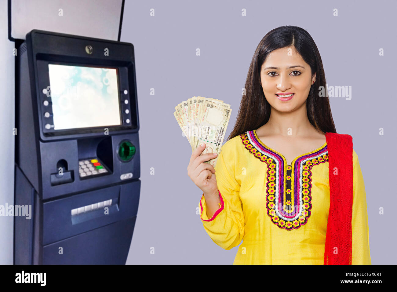 Woman atm holding money hi-res stock photography and images - Alamy